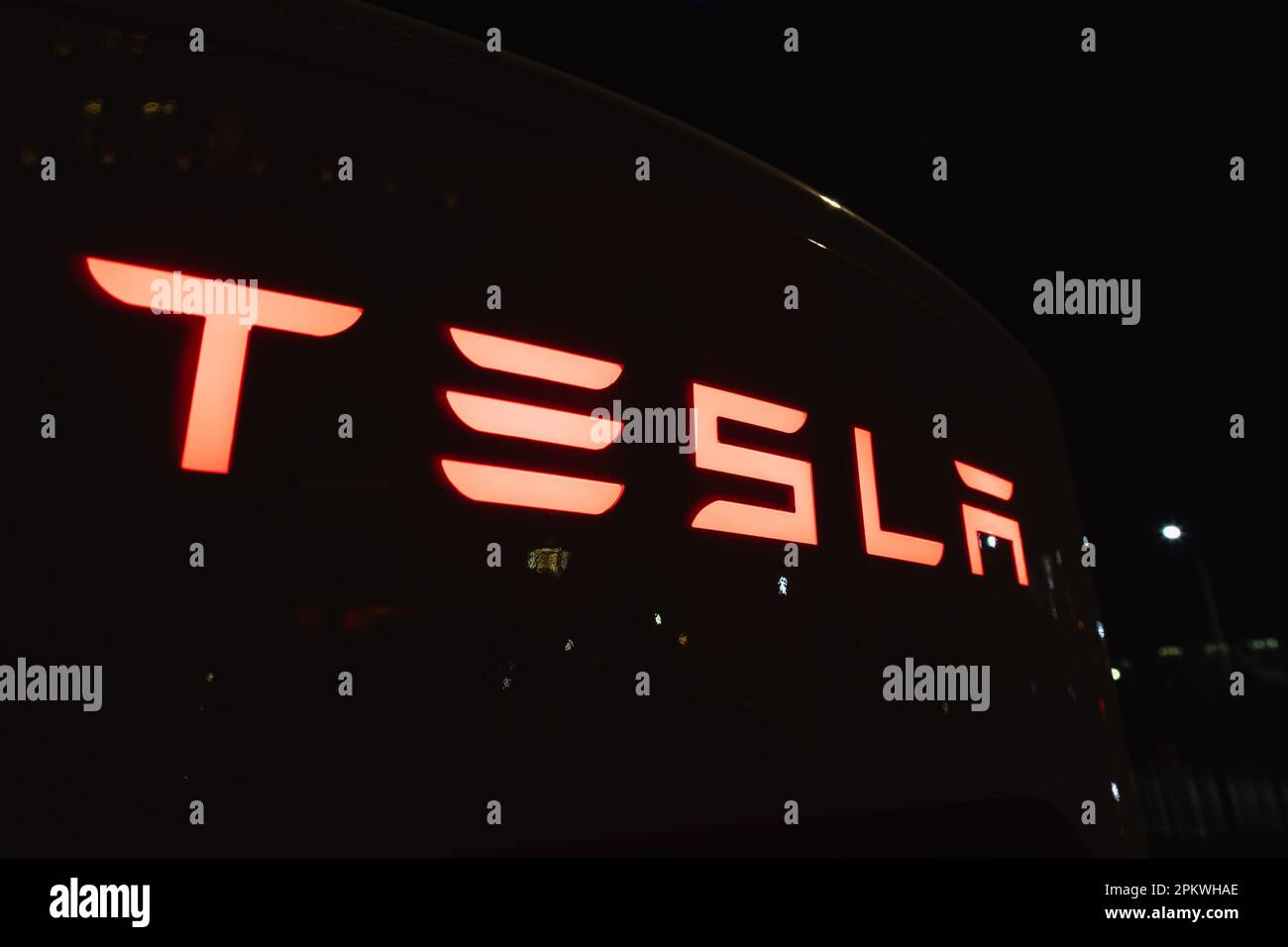 October 20, 2022 Astana, Kazakhstan: Glowing bright red Tesla logo on a ...