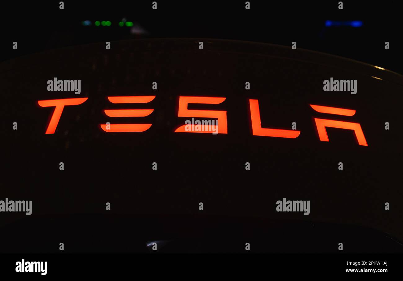 October 20, 2022 Astana, Kazakhstan: Glowing bright red Tesla logo on a ...