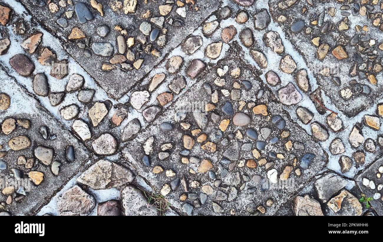 Stone pavement mosaic surface, close up Stock Photo - Alamy
