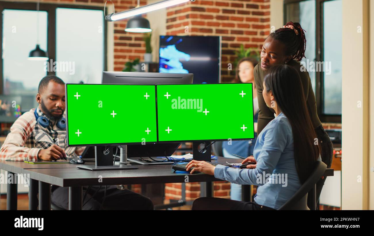 Team Of Diverse Workers Analyzing Computers With Greenscreen Template