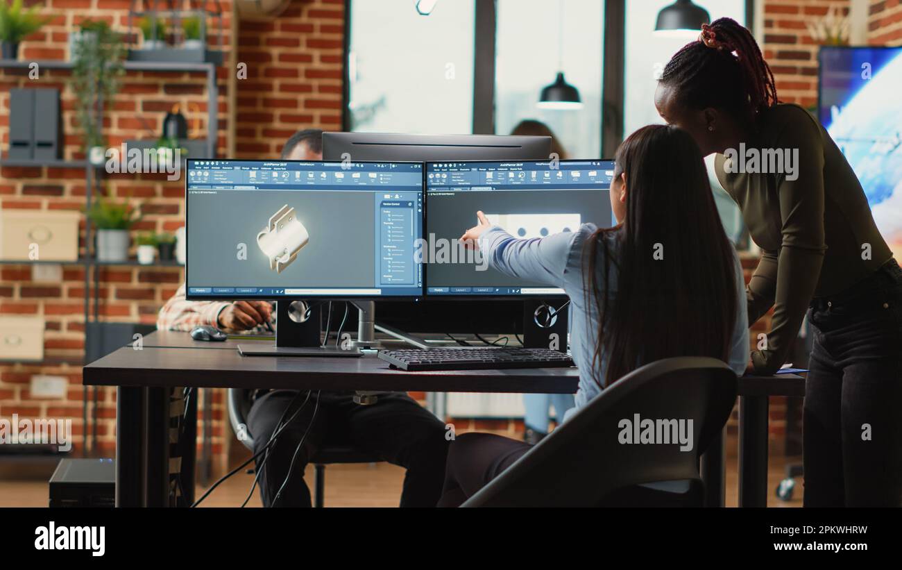 Team of diverse women brainstorming ideas to develop industrial clamp ...