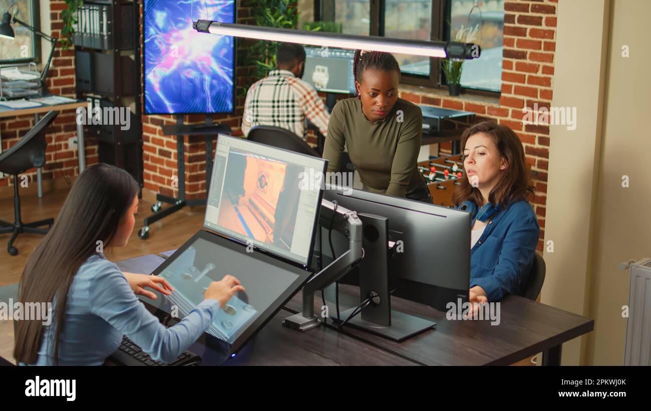 Employees doing it work to develop new interface in agency studio ...