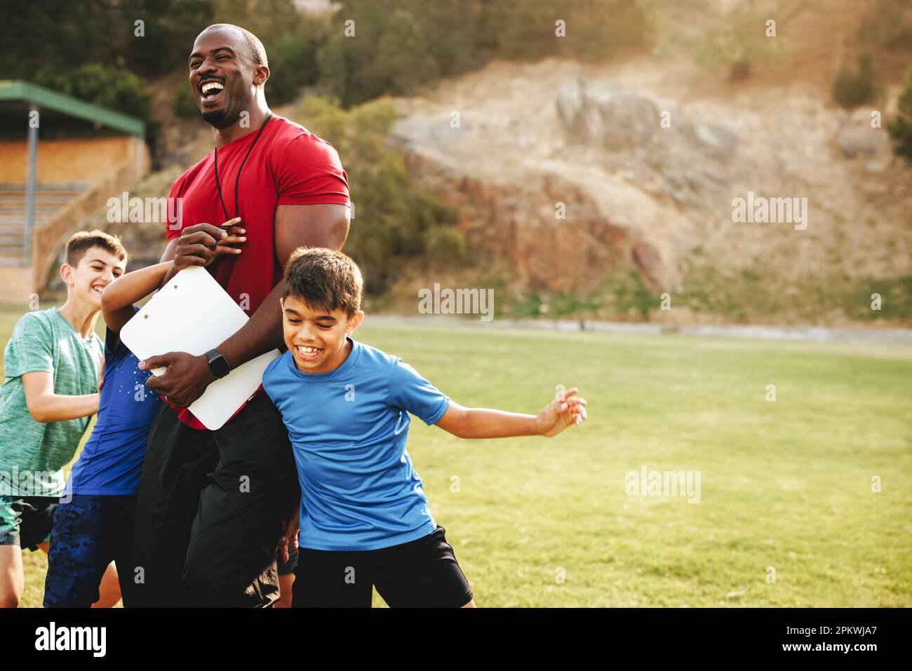 Boys having a fun with their school coach. Teacher and students ...