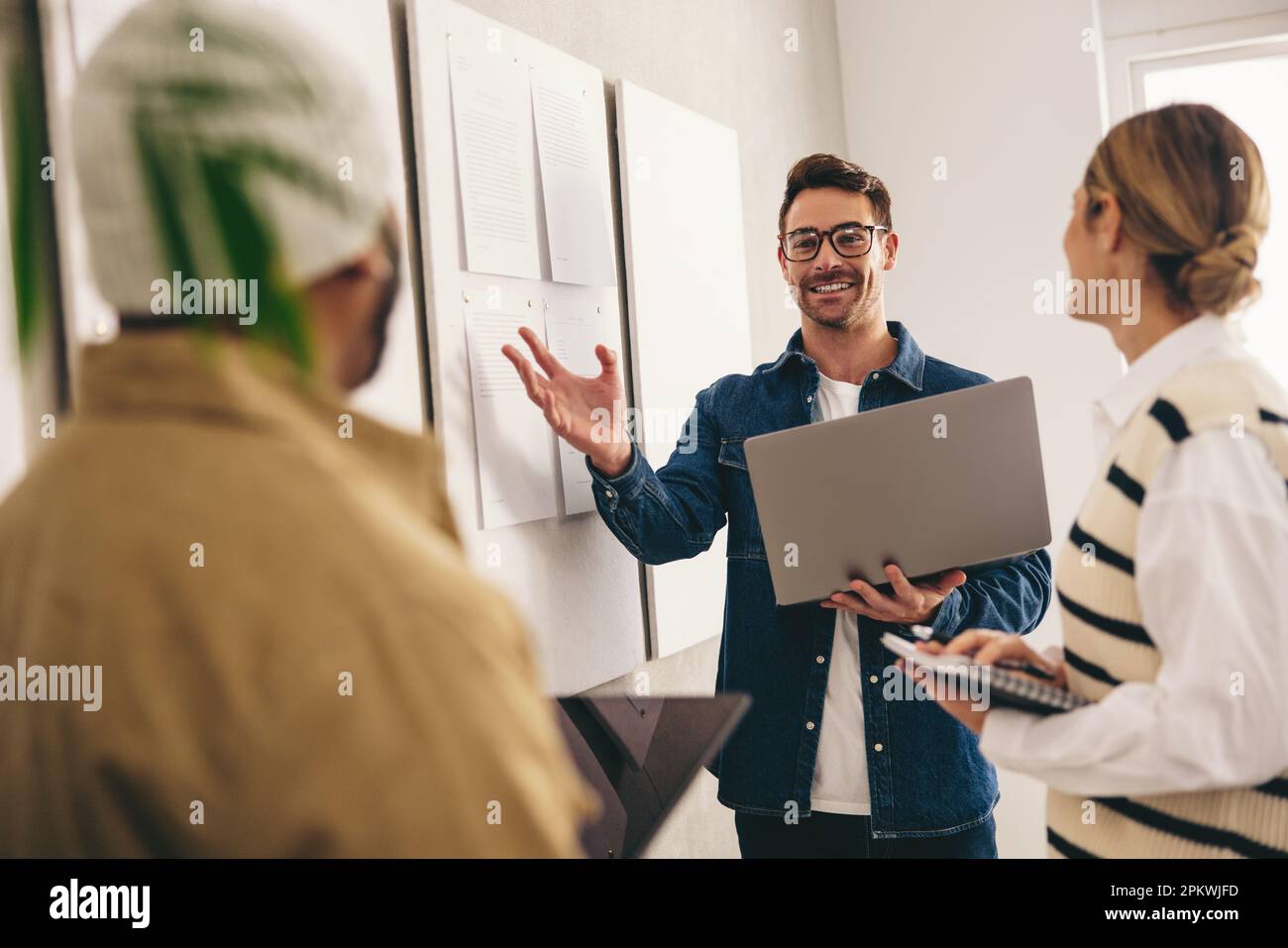 Creative business team having a discussion while standing next to some ...