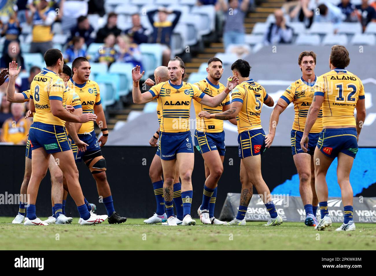 Clint Gutherson of the Eels celebrates scoring a try with team mates ...