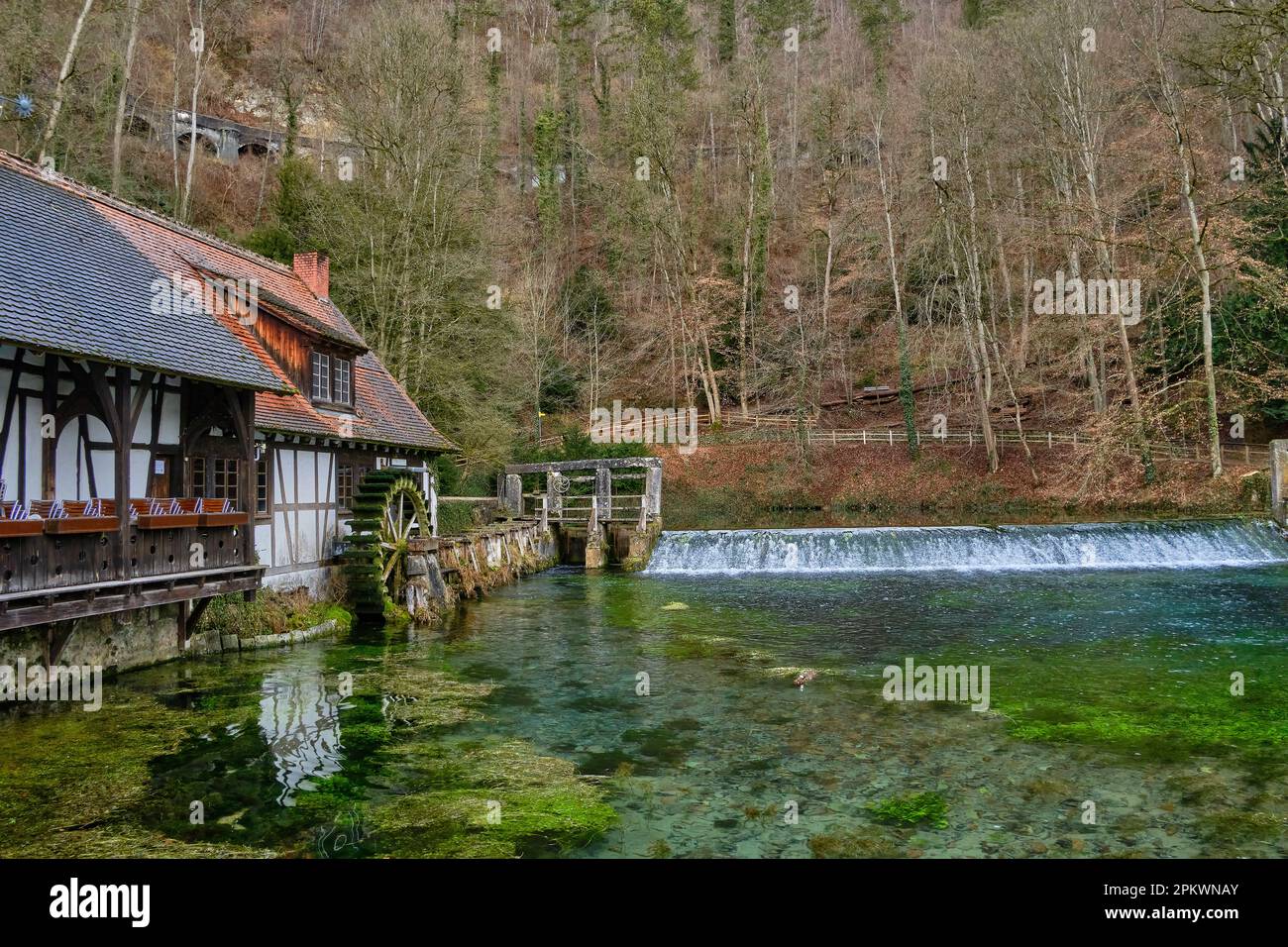 The Blautopf (Blue Pot) with historic hammer mill in Blaubeuren at the ...