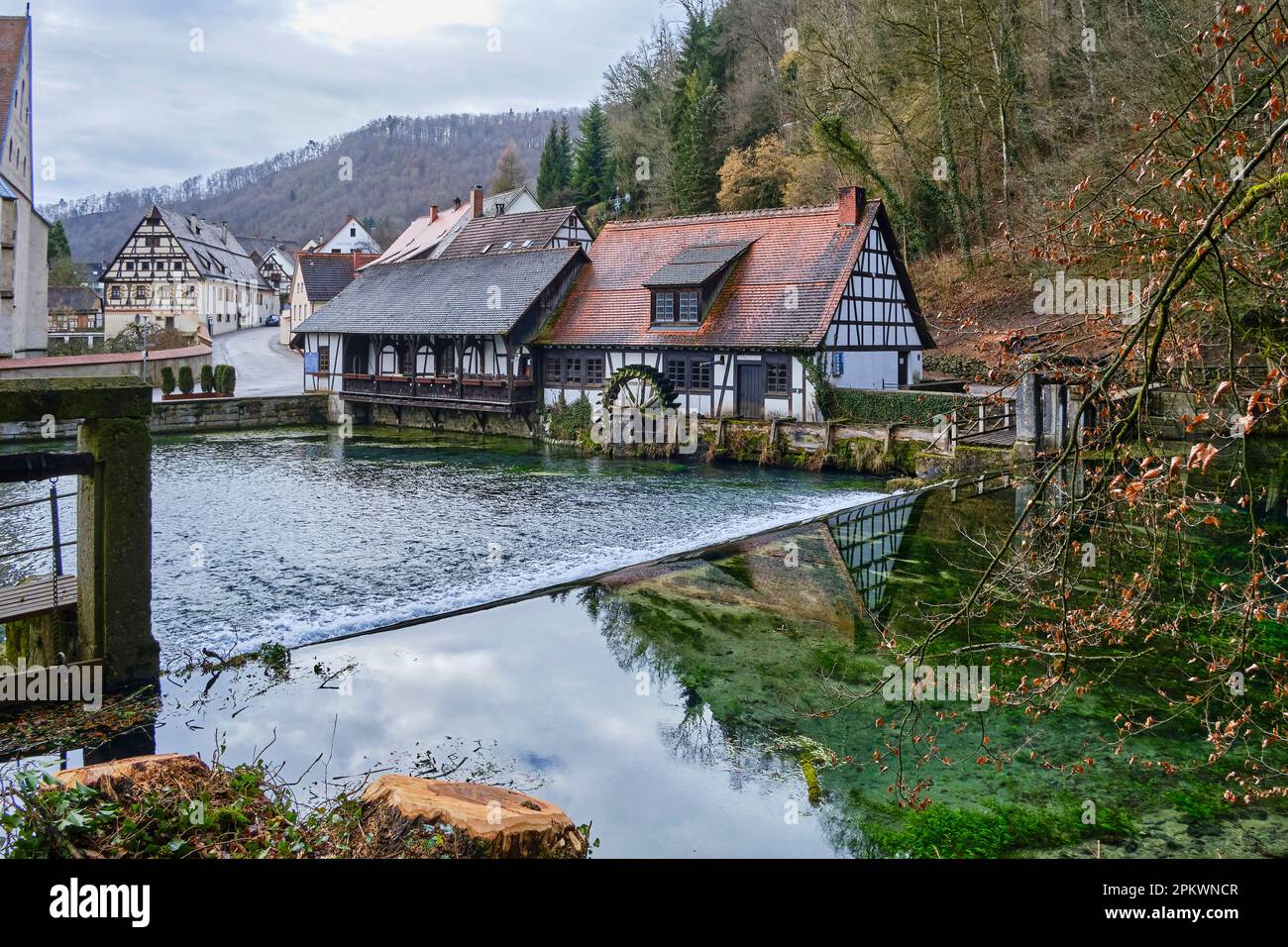 The Blautopf (Blue Pot) with historic hammer mill in Blaubeuren at the ...
