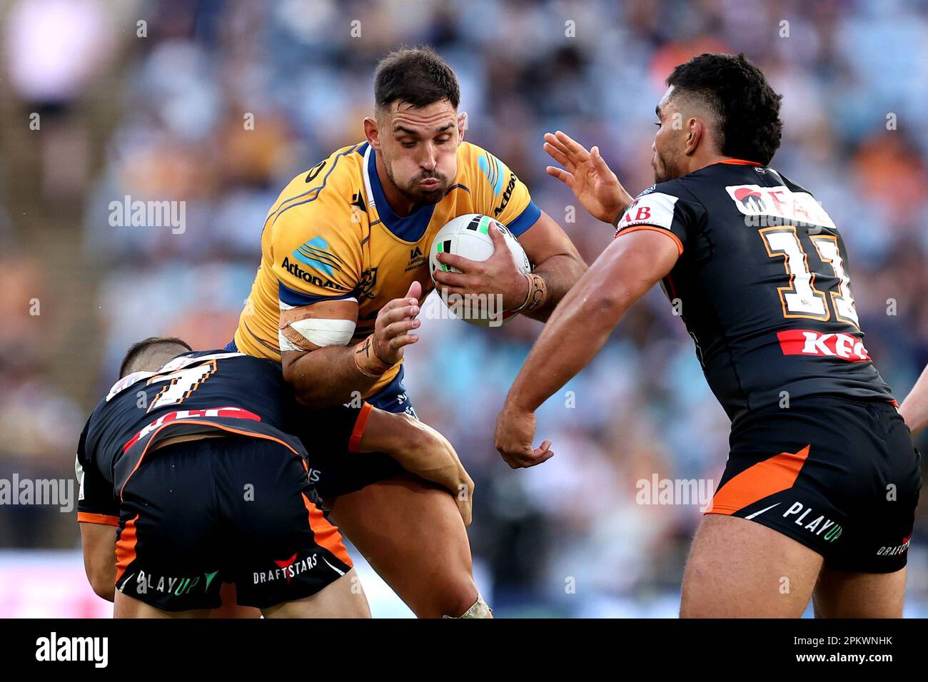 Ryan Matterson of the Eels is tackled by Luke Brooks of the Tigers ...