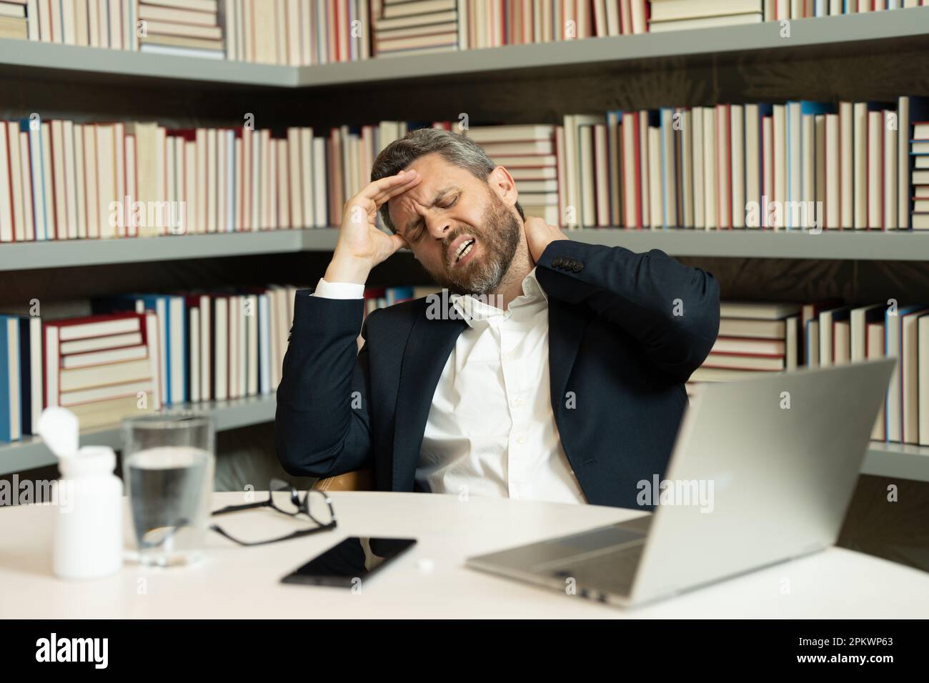 Overworked man feeling migraine head strain. Tired bored man has office ...