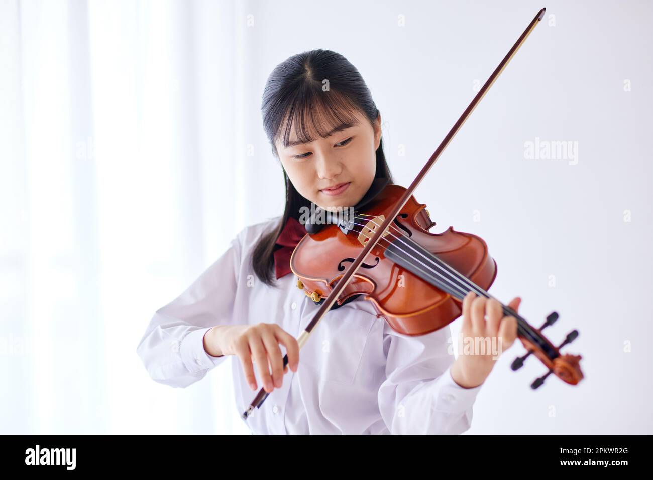 Japanese high school student wearing uniform practicing music Stock ...