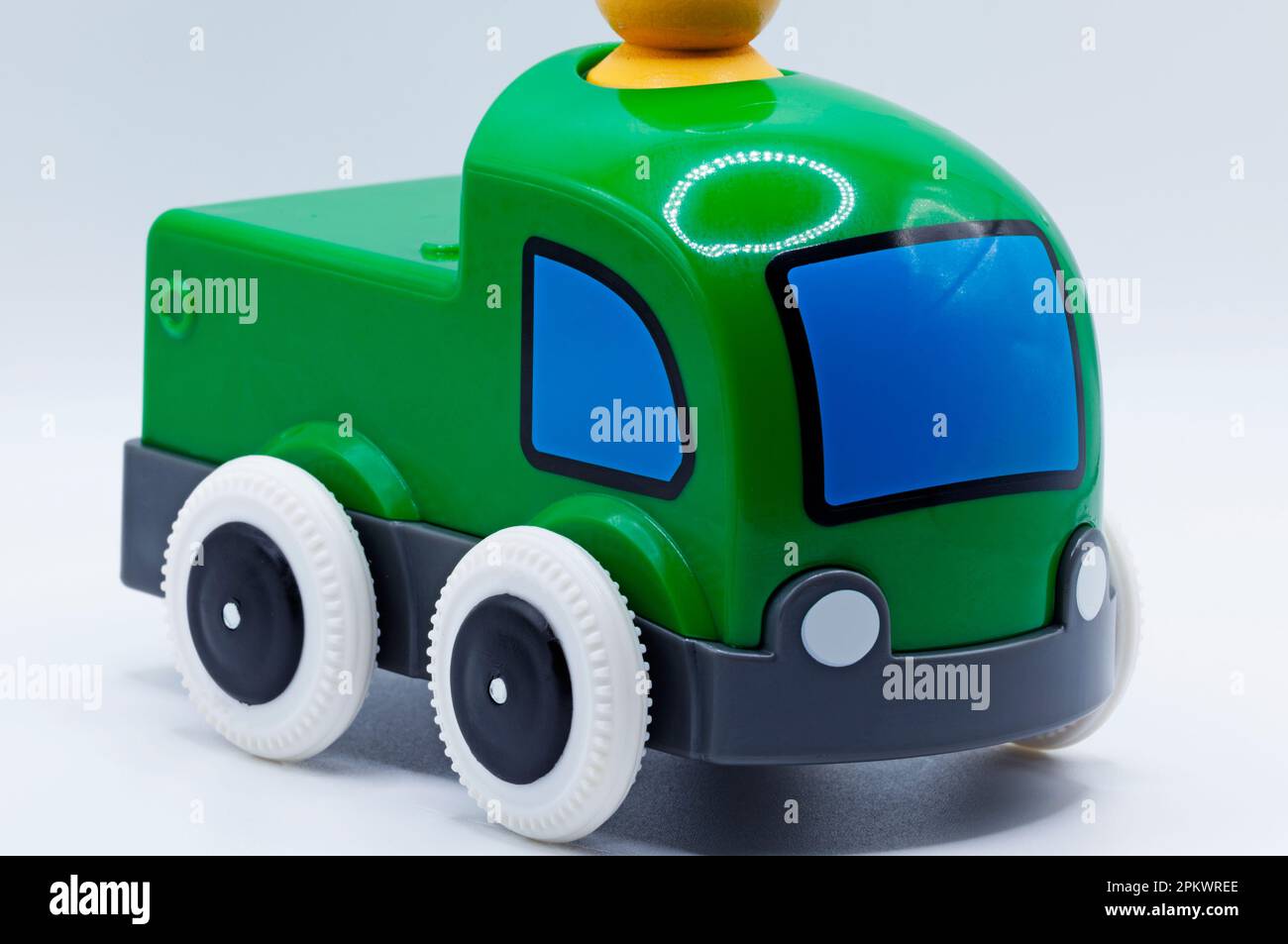 a green toy truck on a white background Stock Photo - Alamy