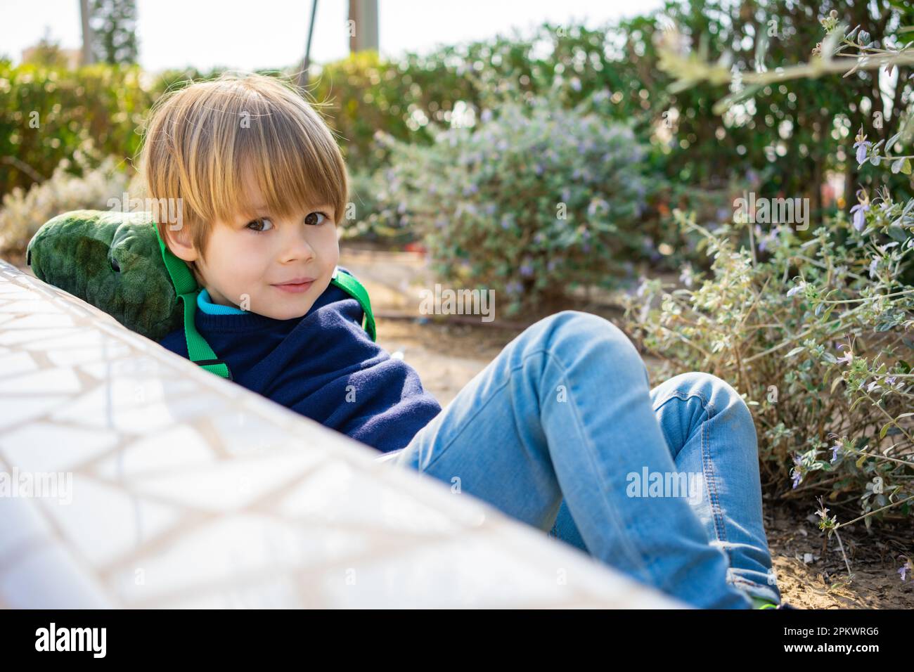 Child on spring nature background. Sweet, happy child boy playing ...