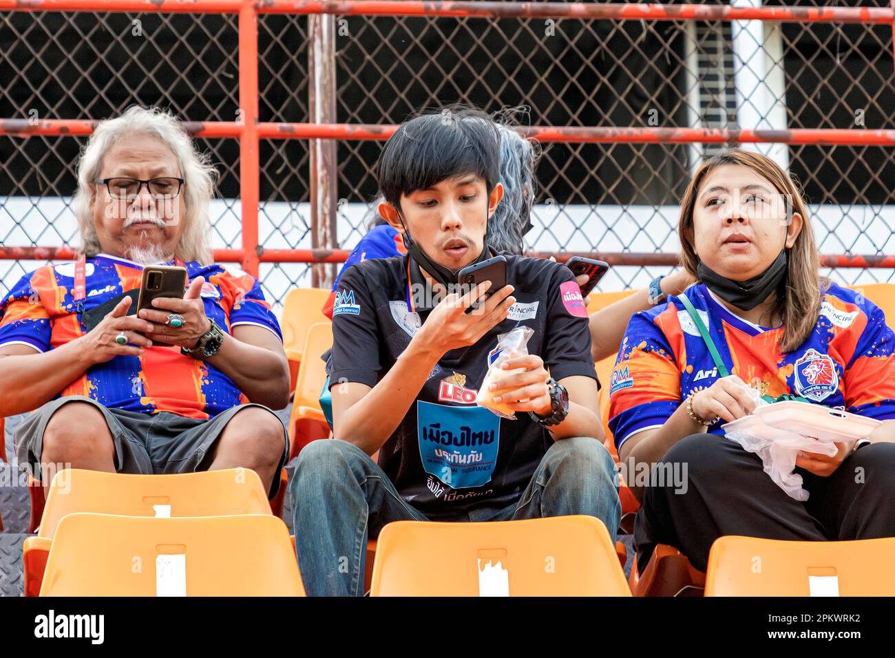 Port F.C. supporters and spectators using mobile phone at Thai football ...