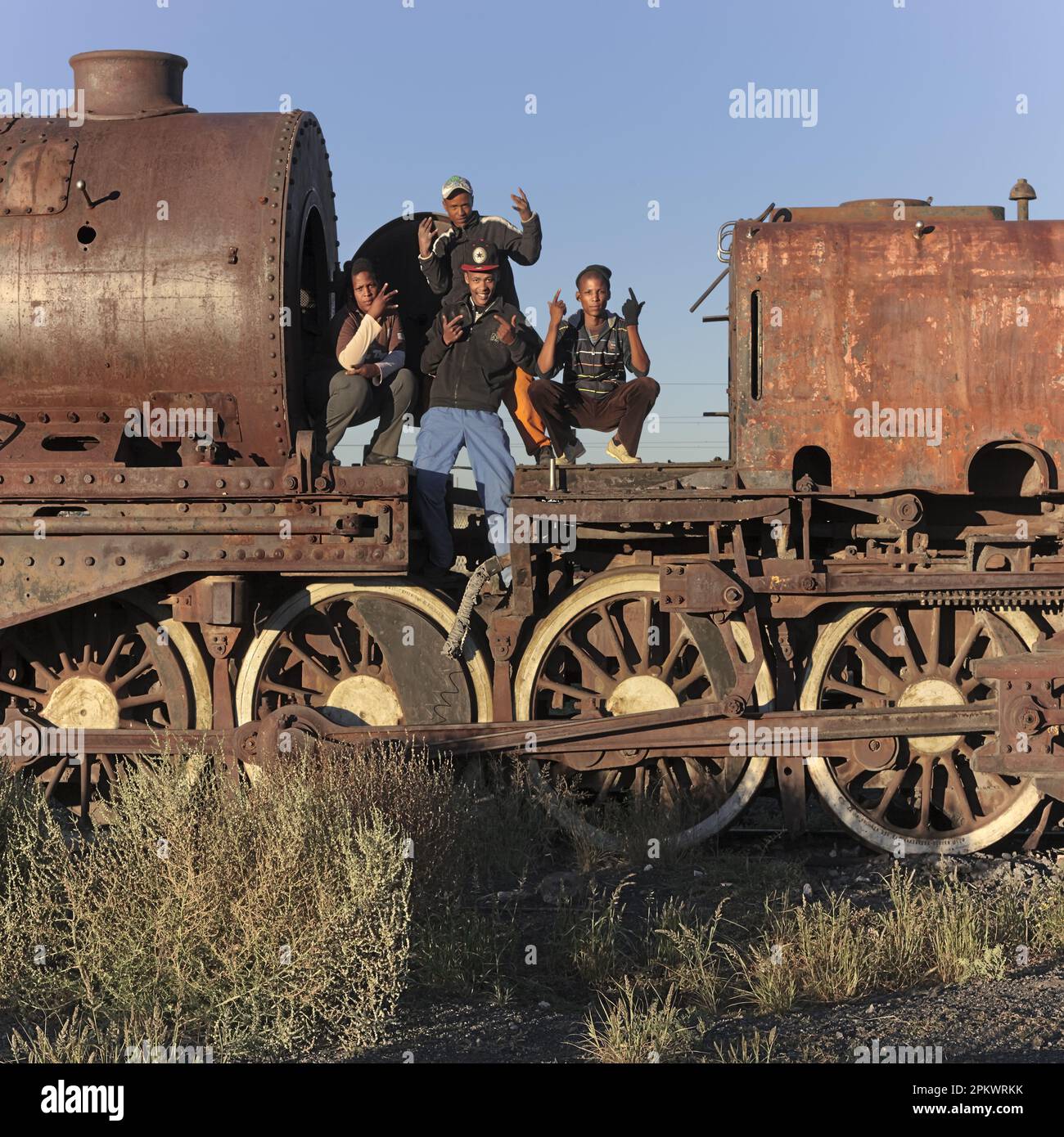 Coloured youths show off their rapper skills on a steam locomotive of ...