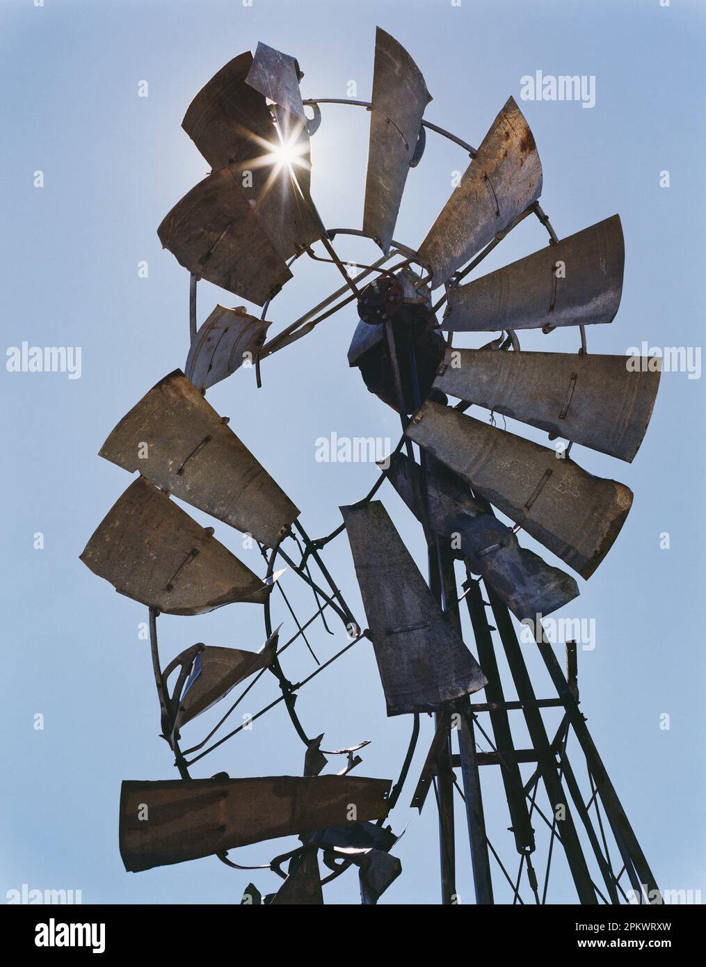 A broken windmill hangs by its last limbs in the landscape north of the ...