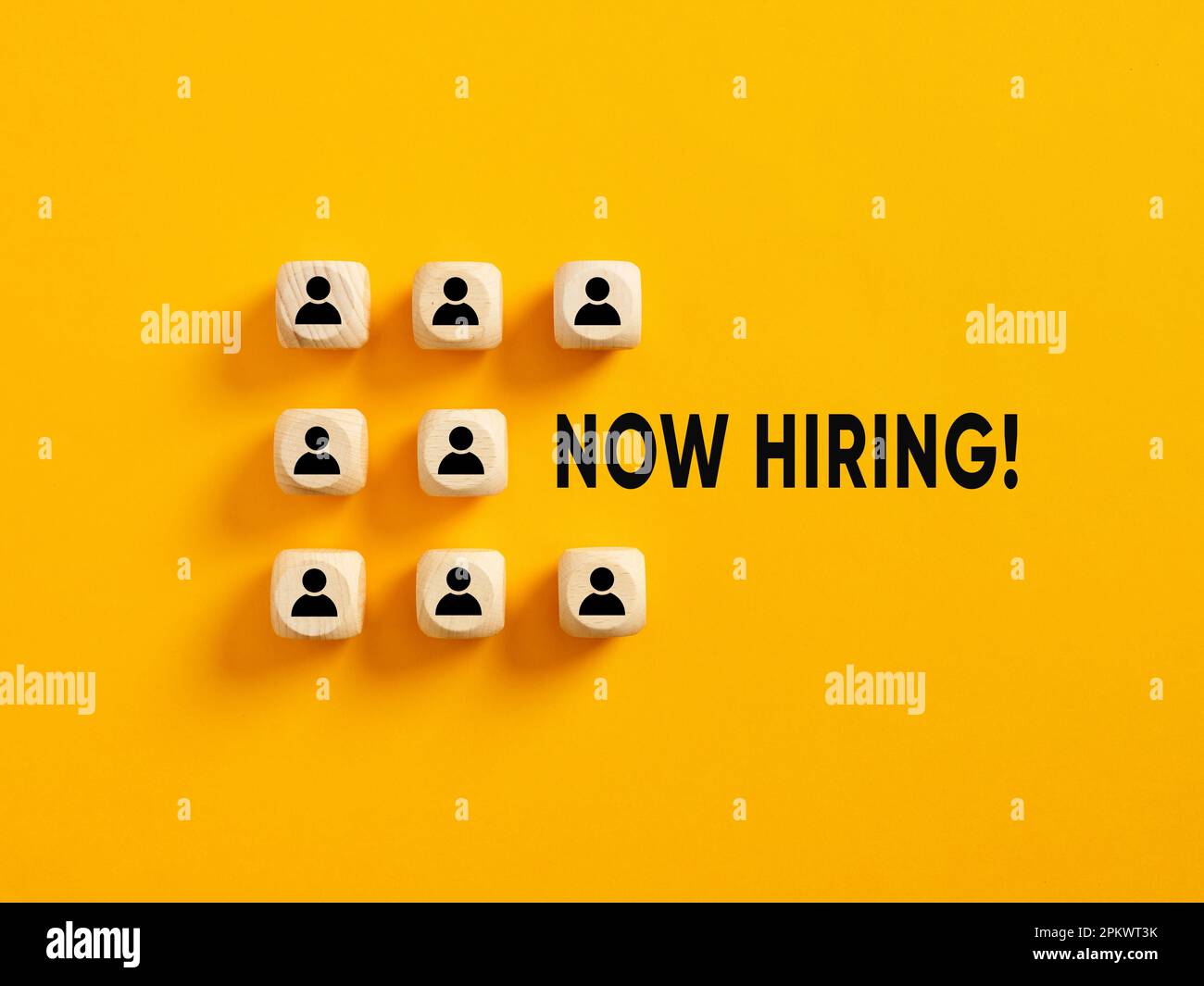 Employee symbols on wooden blocks with the message now hiring. Job ...