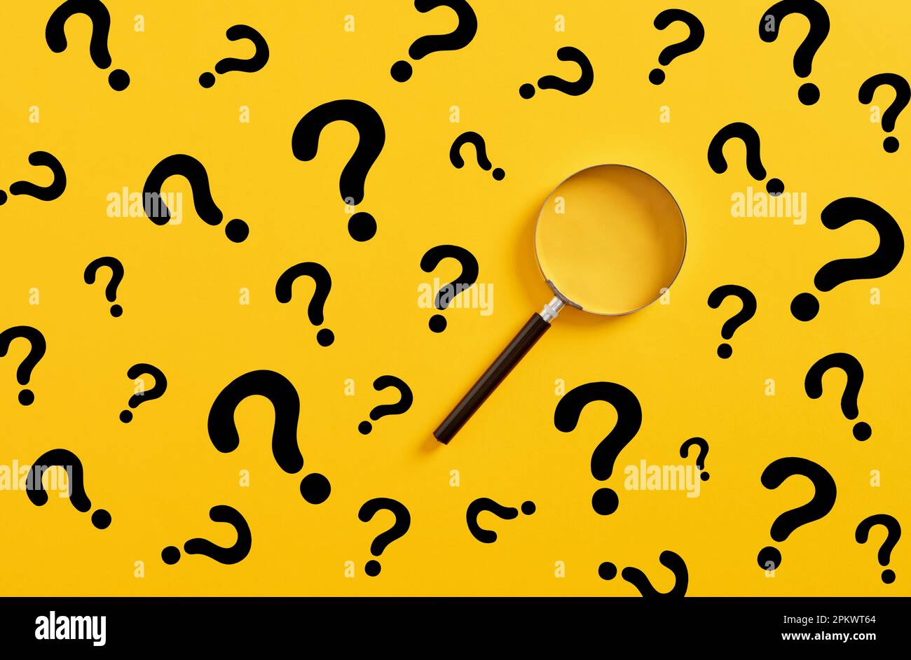 Magnifying glass and question mark signs on yellow background ...