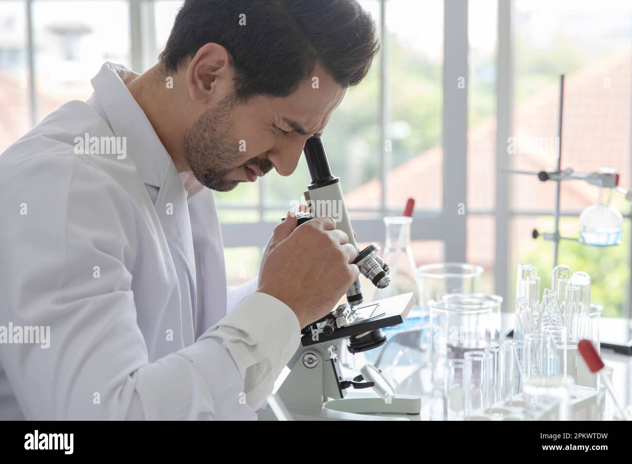 Young scientist medical worker in lab , doing a microscope analysis in ... Young scientist medical worker in lab , doing a microscope analysis in ...