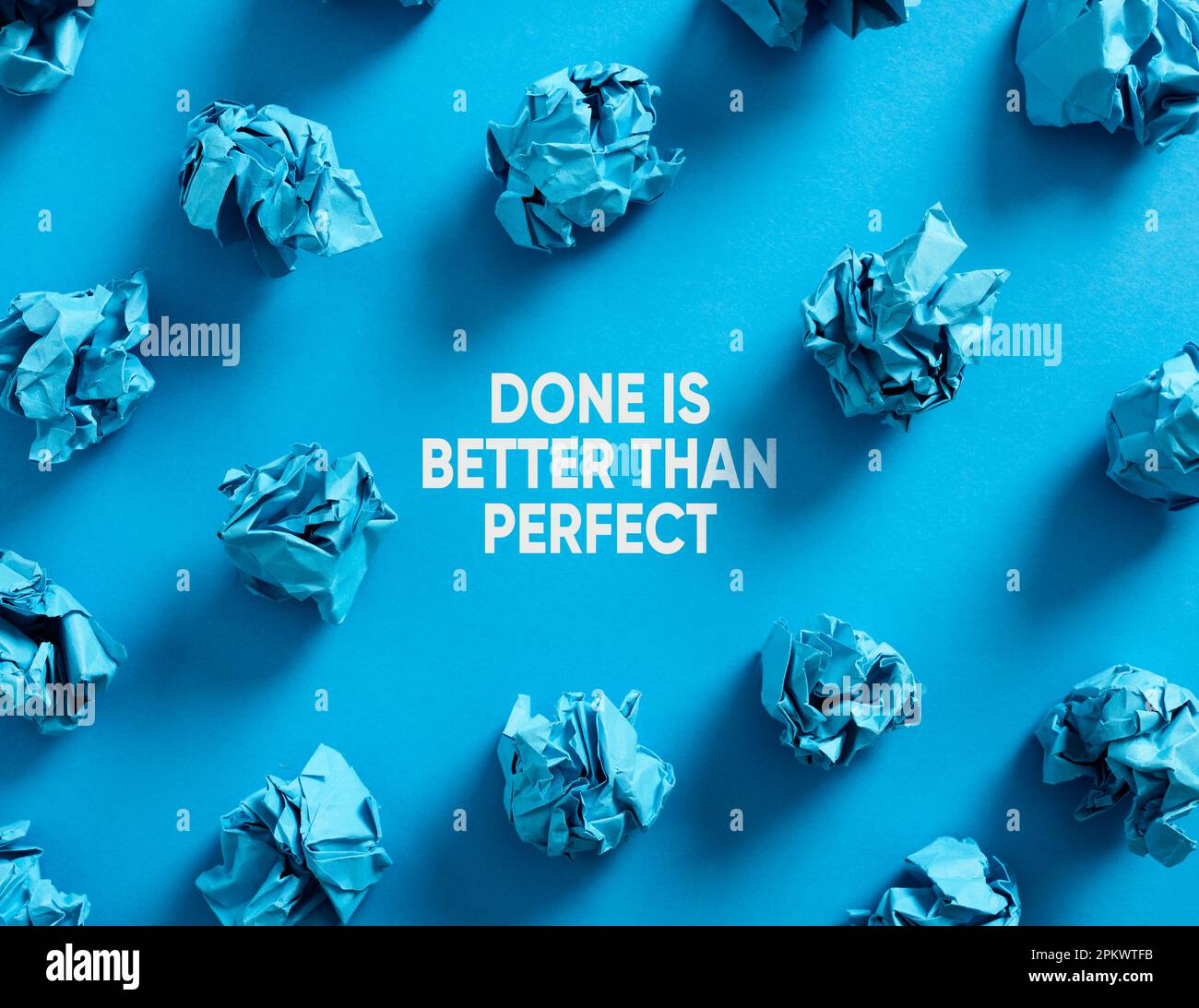 Done is better than perfect message with crumpled blue paper balls on ...