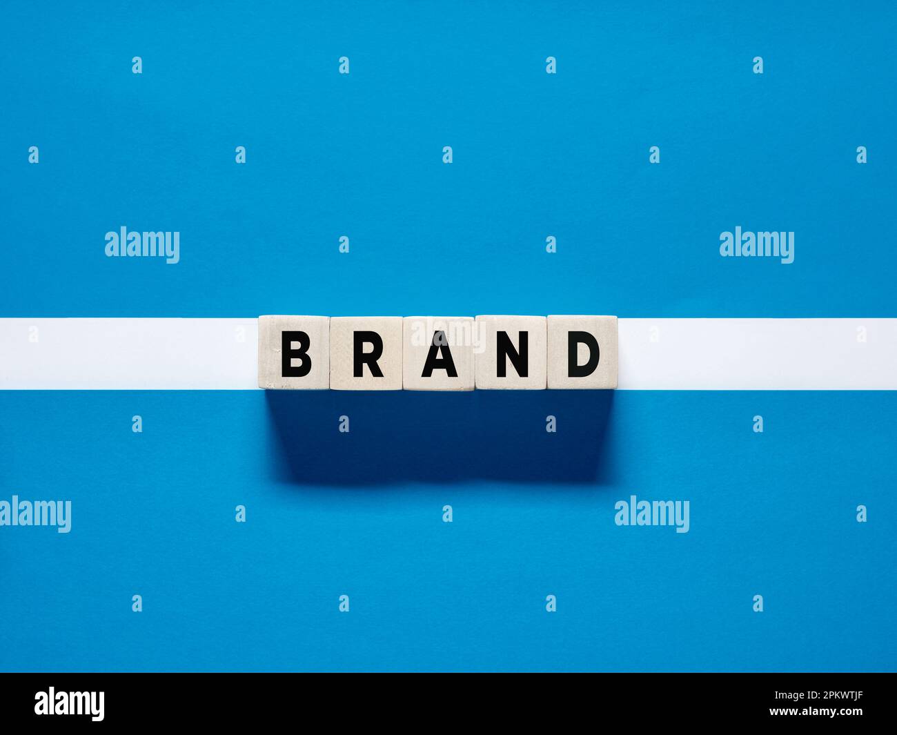 The word Brand on wooden cubes on blue white background. Brand ...