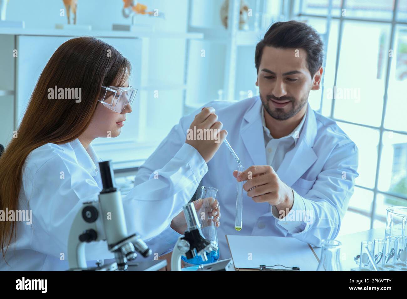 Attractive scientist medical worker with sample test tube at laboratory ...