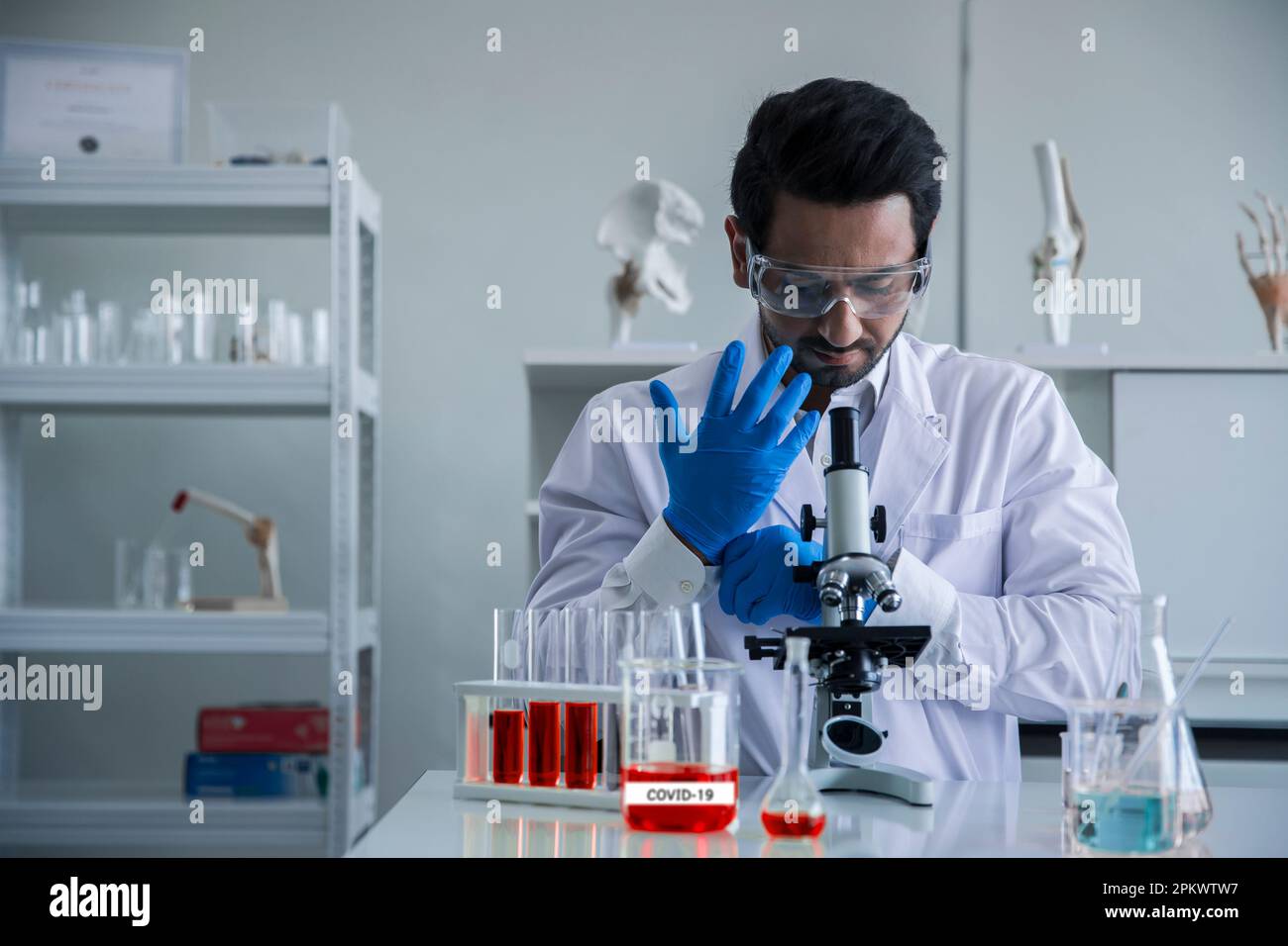 Attractive scientist medical worker with sample test tube at laboratory ...