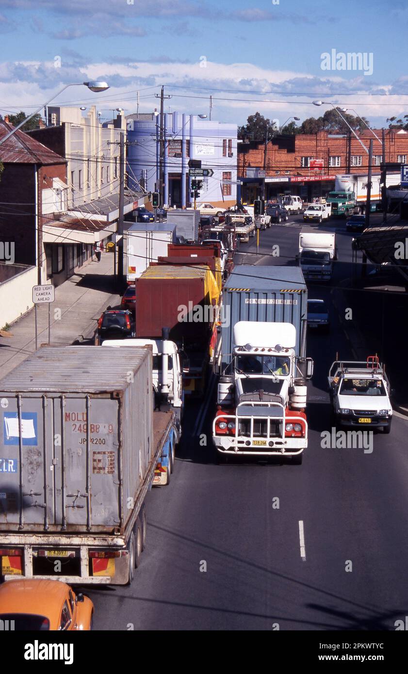 HEAVY TRAFFIC MAKES IT'S WAY SLOWLY THROUGH A SYDNEY SUBURBAN STREET AT ...