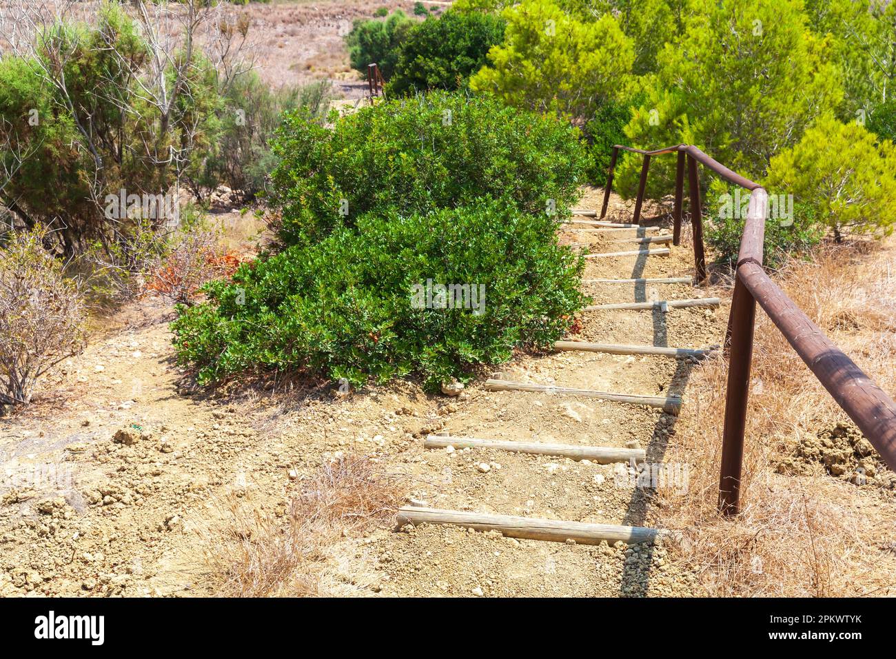 Tourist trail with handrails and stairs going down the hill Stock Photo ...