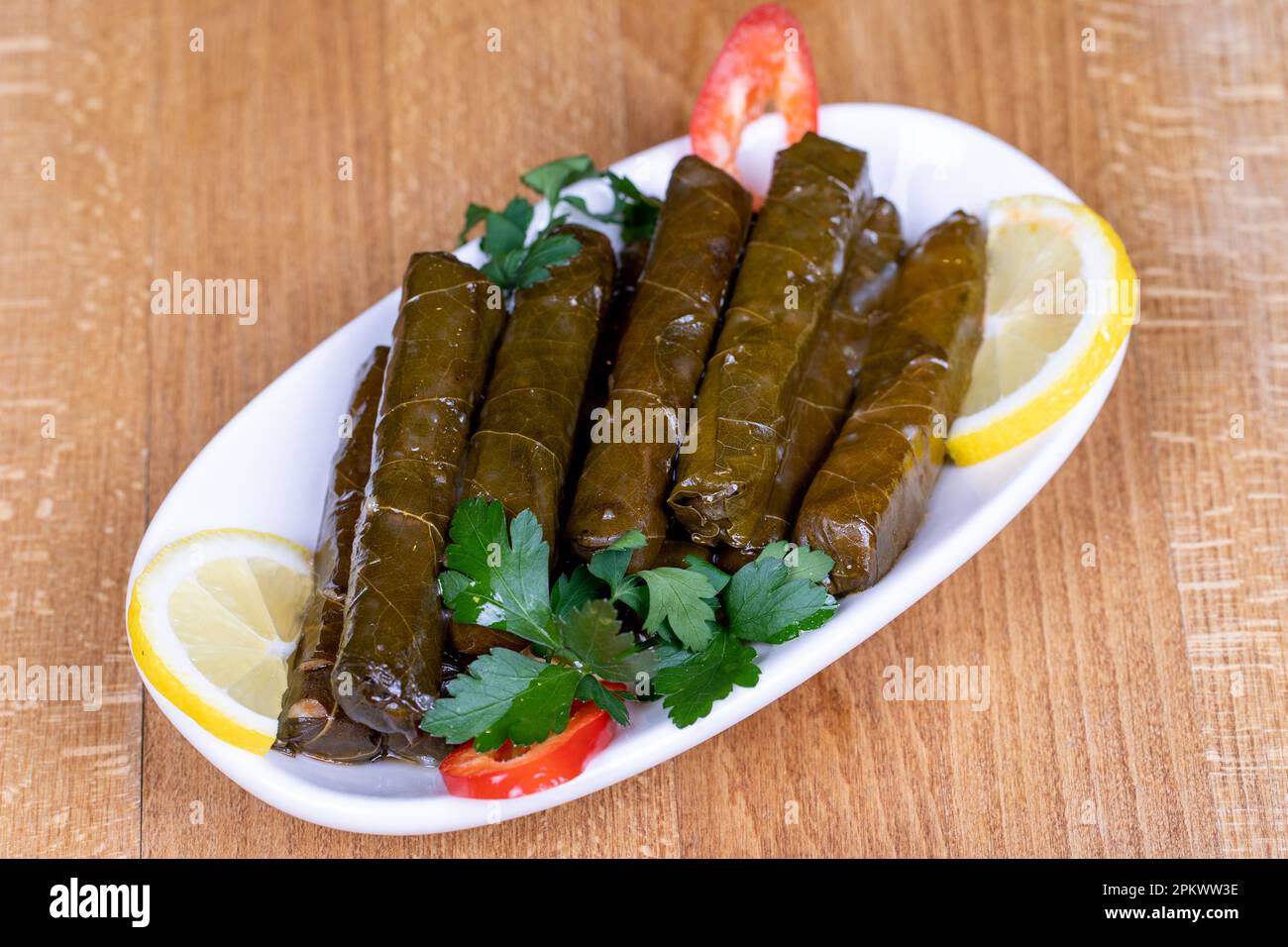 Turkish leaf wrap. Grape leaf wrap with olive oil on wood background ...