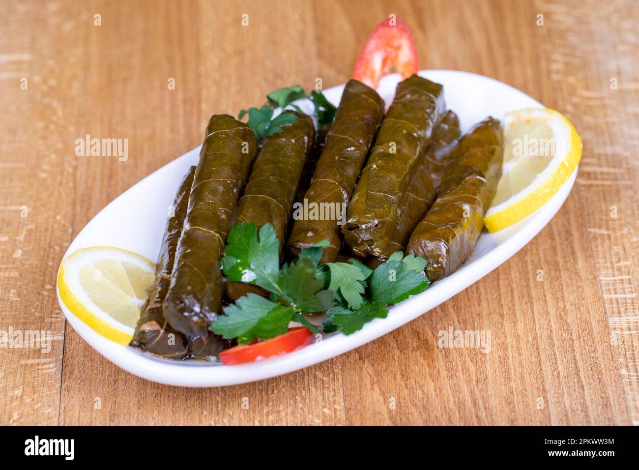 Turkish leaf wrap. Grape leaf wrap with olive oil on wood background ...