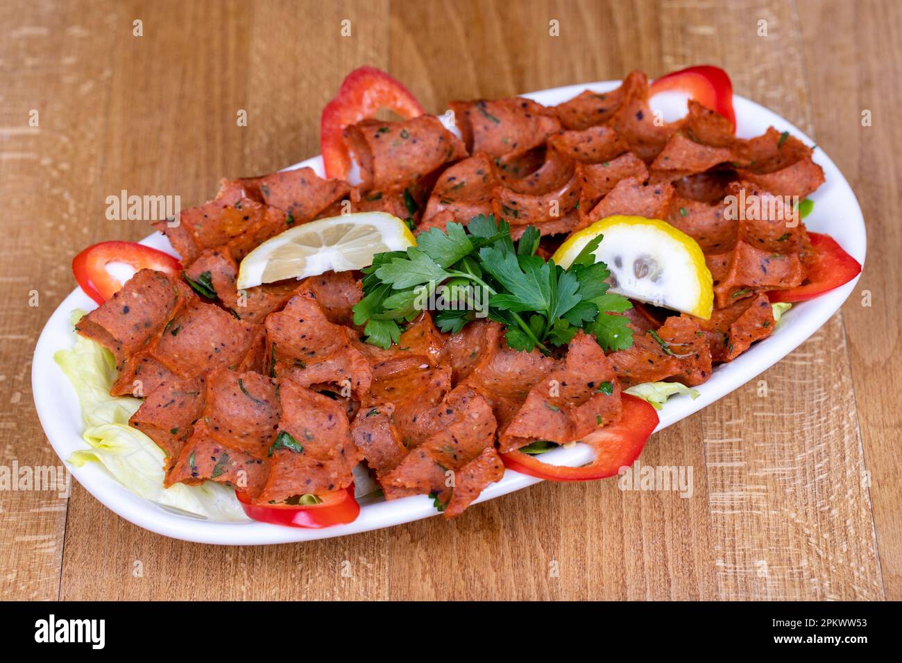 Turkish raw meatballs or bulgur meatballs. Raw meatballs on wood ...