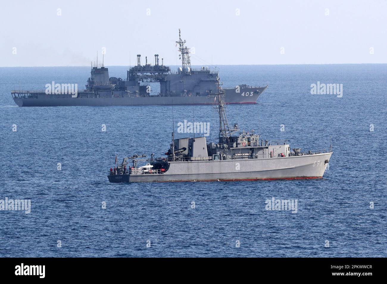 The Shishijima (background), a minesweeper vessel, and the Chihaya, a ...