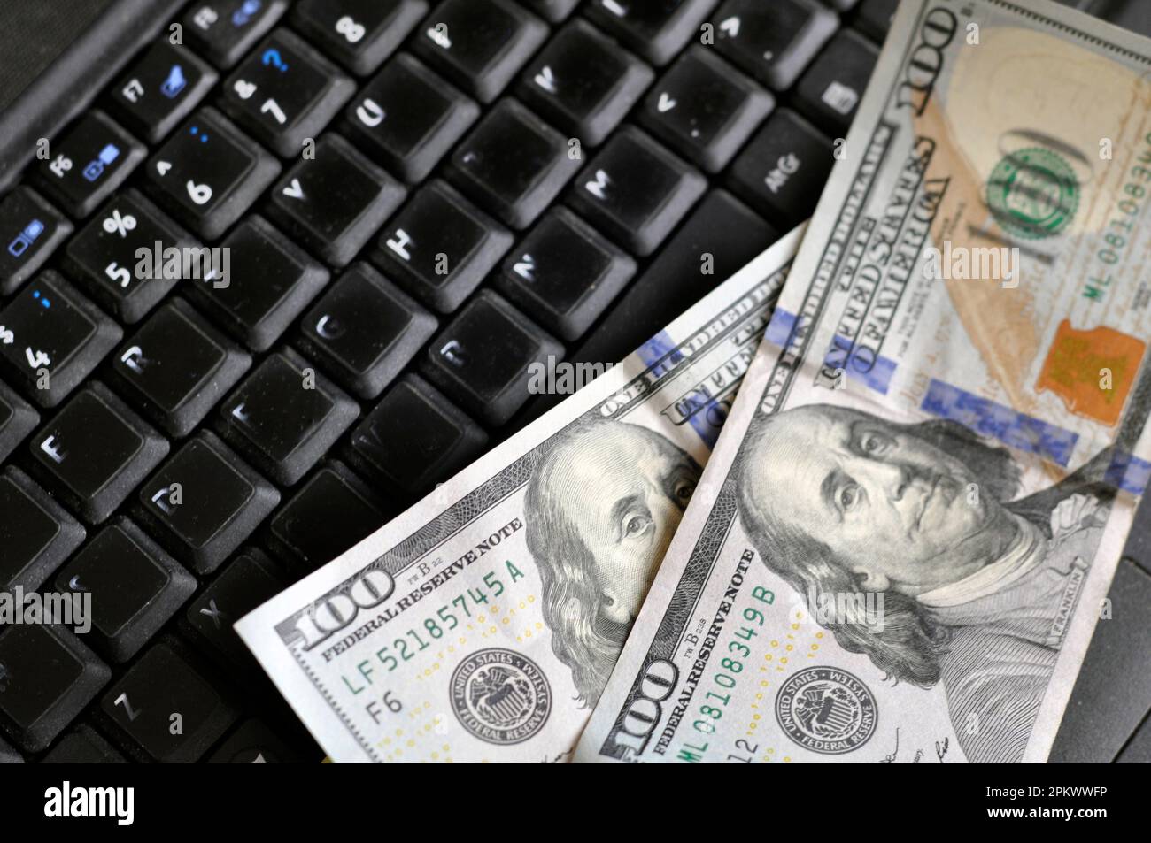 Close-up US dollars on an old laptop with a worn out keyboard Stock ...