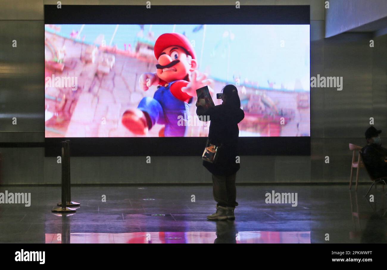 SHANGHAI, CHINA - MARCH 16, 2023 - Fans pass a promotional video of ...