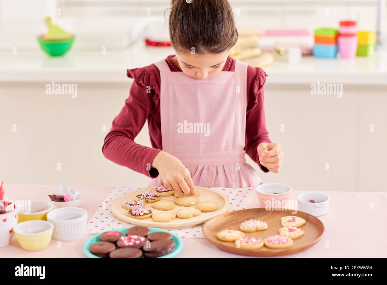 Smiling young girl making sweets Stock Photo - Alamy