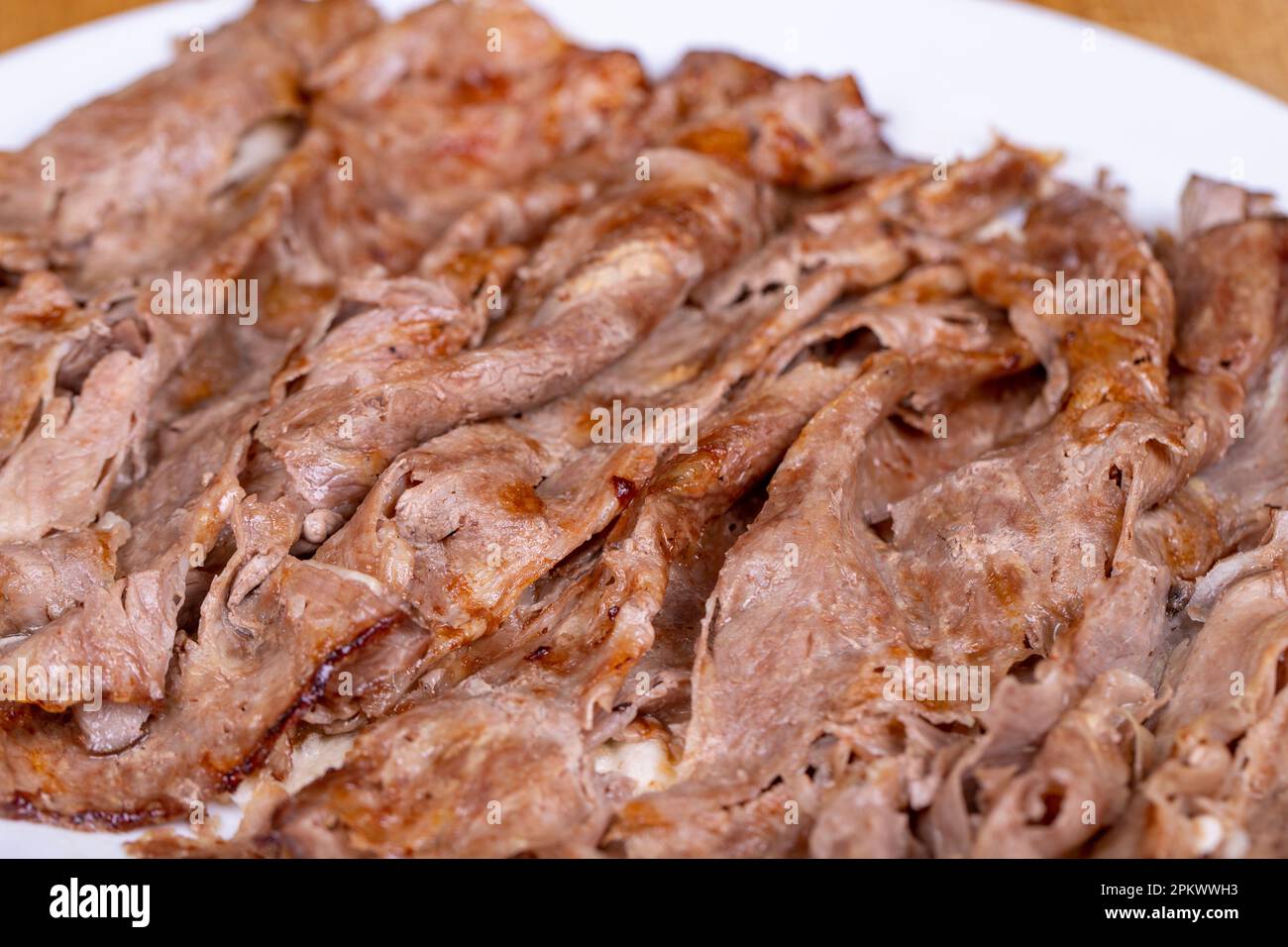 Meat doner kebab. Turkish doner kebab on wood floor. Turkish cuisine delicacies. Food tourism ...