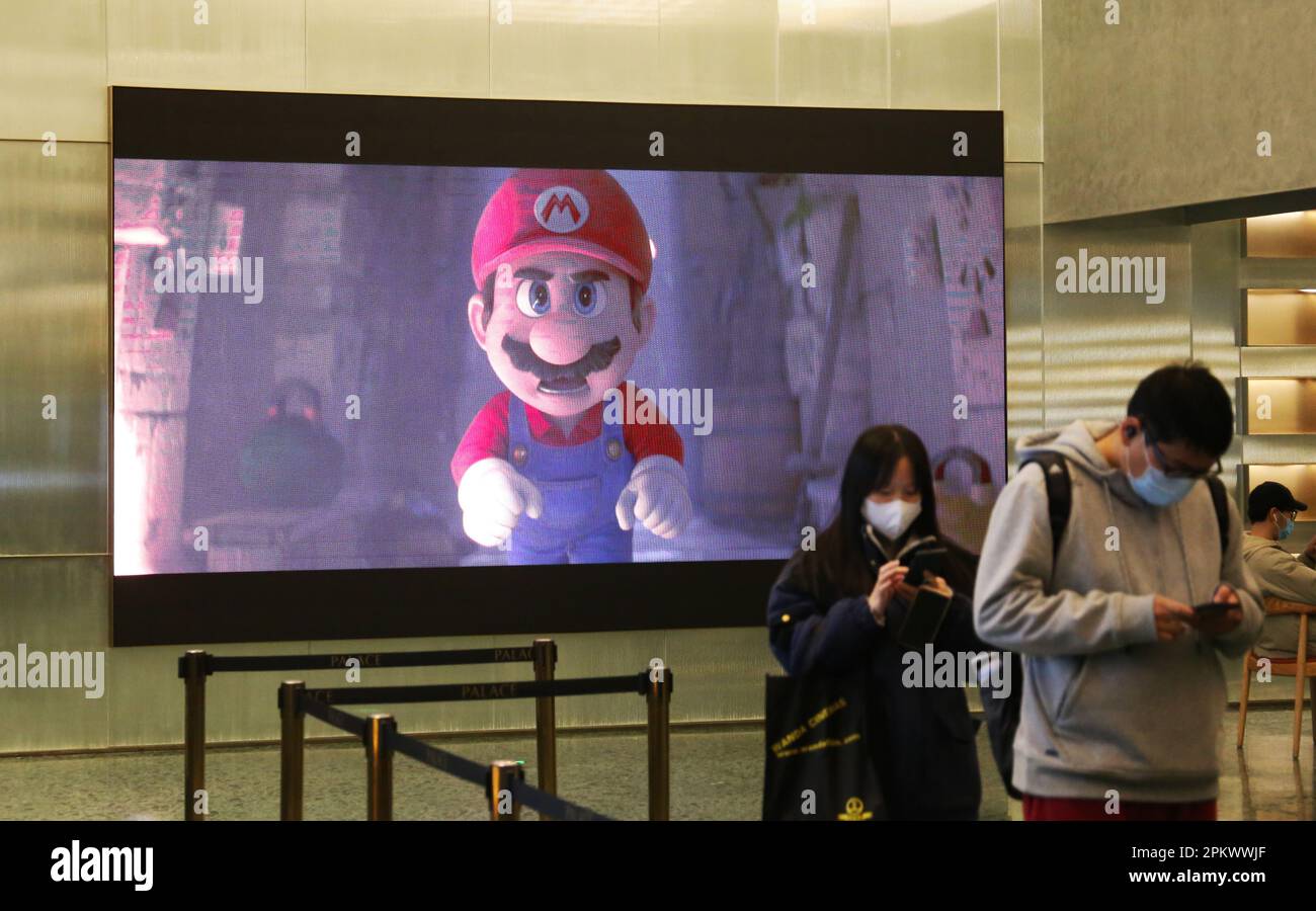 SHANGHAI, CHINA - MARCH 16, 2023 - Fans pass a promotional video of ...