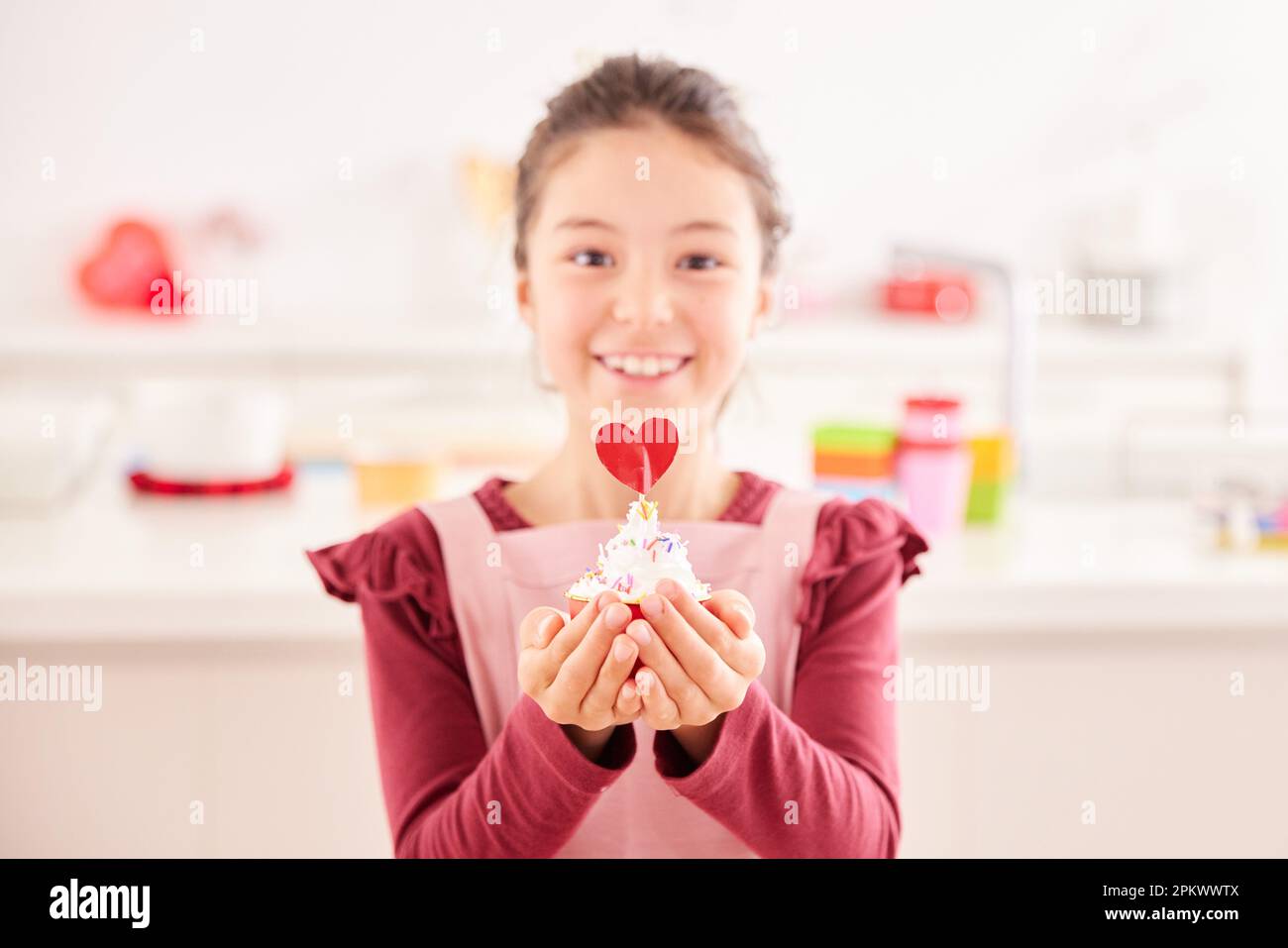 Smiling young girl making sweets Stock Photo - Alamy