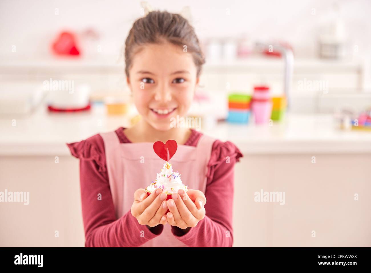 Smiling young girl making sweets Stock Photo - Alamy