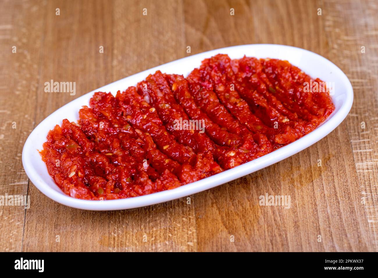 Chili paste. Hot snack prepared with pepper paste in a ceramic bowl ...