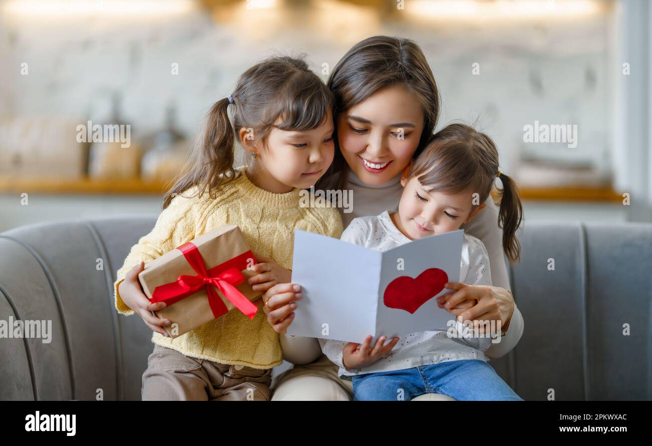 Happy mother's day. Children daughters congratulating their mother and ...
