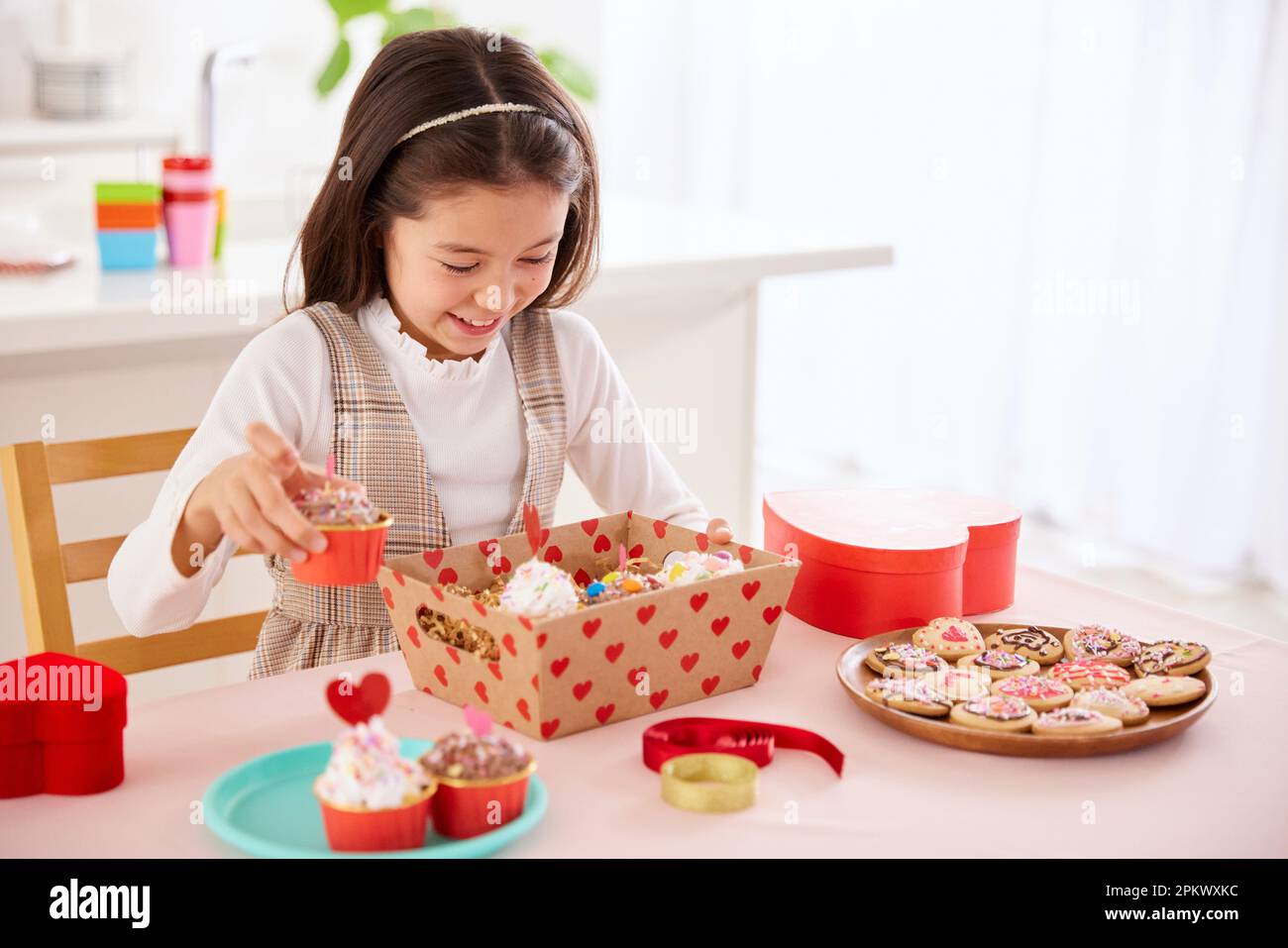 Smiling young girl making sweets Stock Photo - Alamy