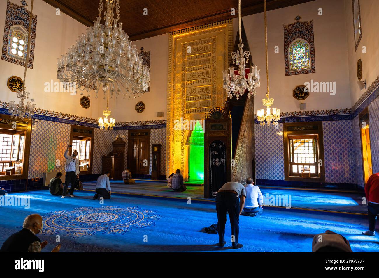 Haci Bayram Veli Mosque and praying muslim men. Ankara Turkiye - 5.16. ...