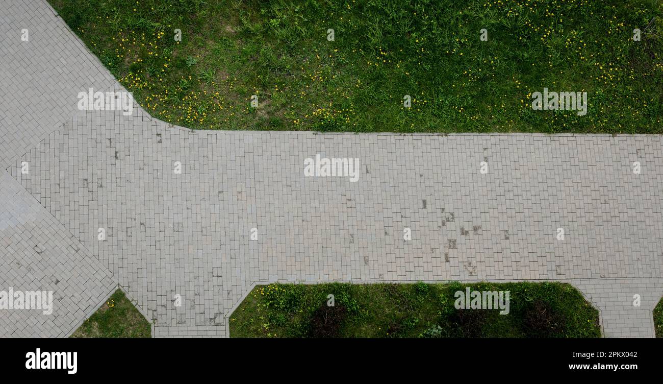 Top view of green grass texture with cement sidewalk. areal view ...