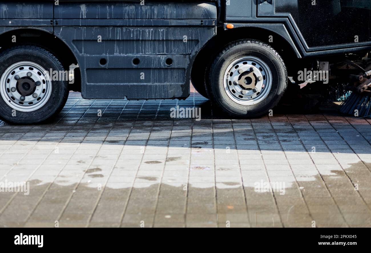 urban sweeper cleans road from dirt with a round brush. Street cleaner ...