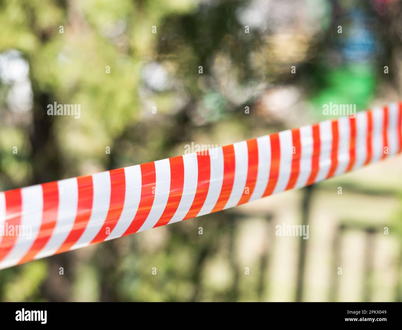 Close up with a red white warning tape Stock Photo - Alamy