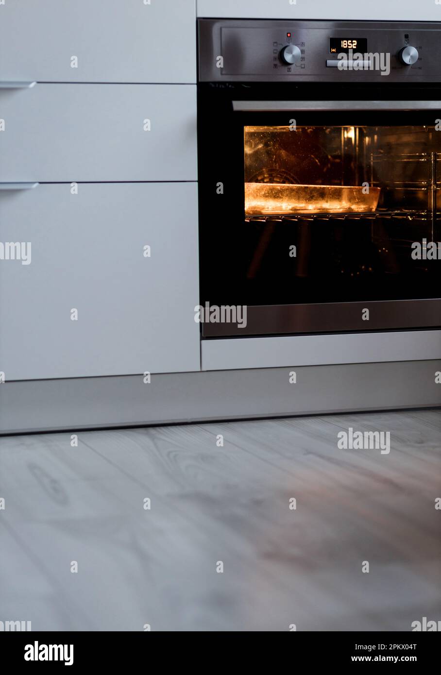 cooking in the built-in oven. modern kitchen with appliances Stock ...