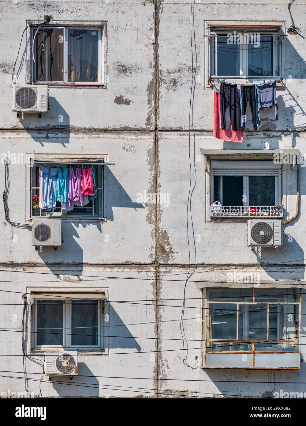 Worn out apartment building from the communist era against blue sky in ...