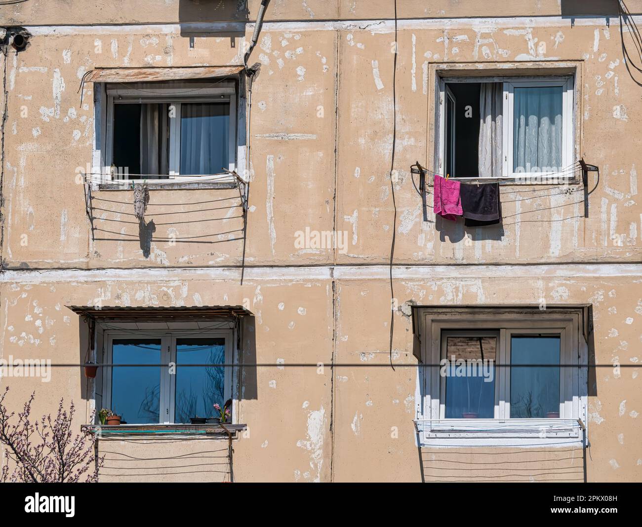 Worn out apartment building from the communist era against blue sky in ...