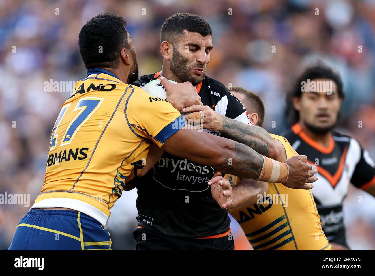 Alex Twal of the Tigers is tackled by the Eels defence during the NRL ...